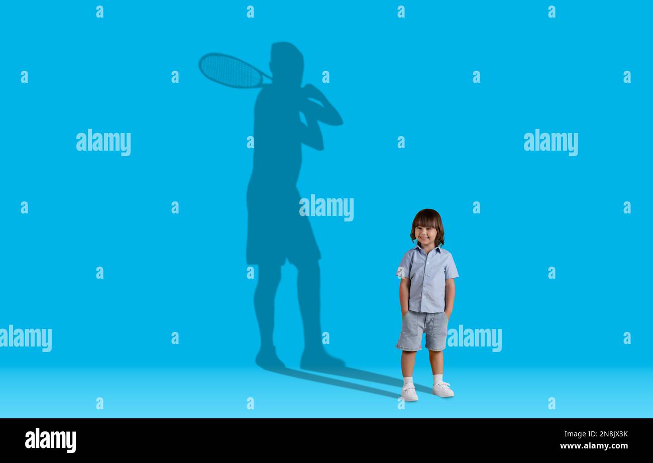 Tennis player shadow over cute smiling preschool boy Stock Photo - Alamy