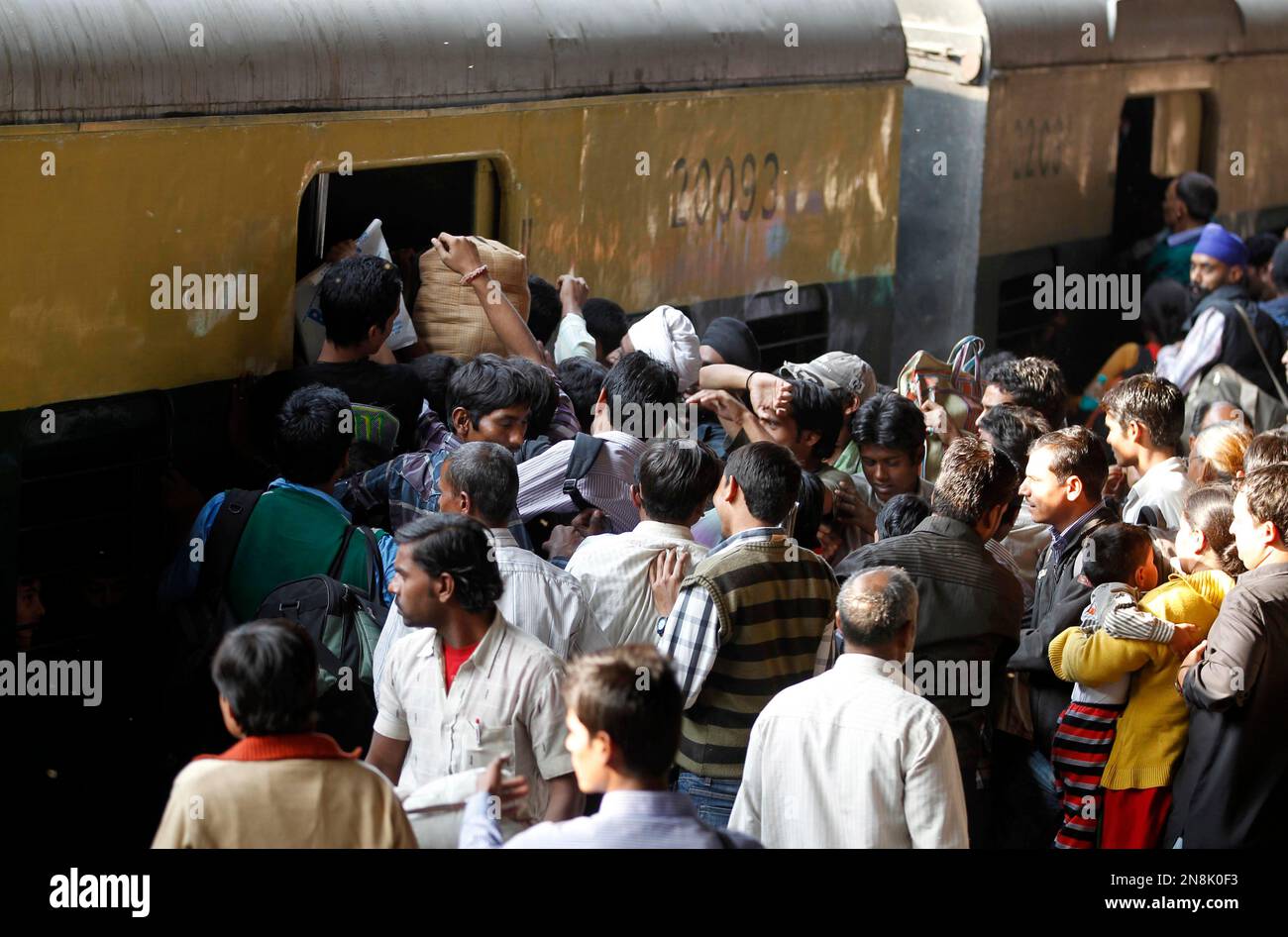 Indians headed to the state of Bihar crowd a railway platform as they ...