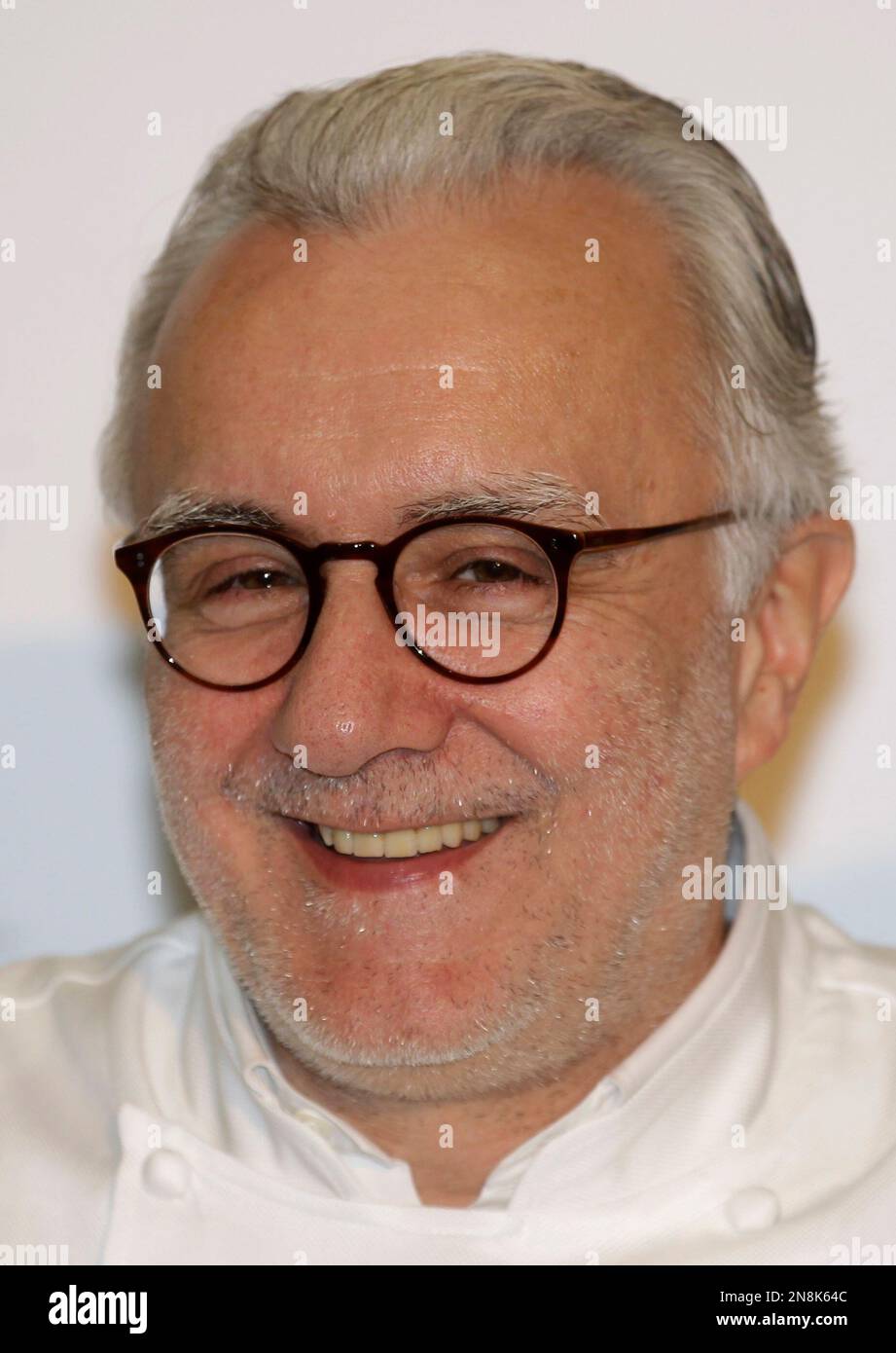 French chef Alain Ducasse poses for photographers as he celebrates the ...