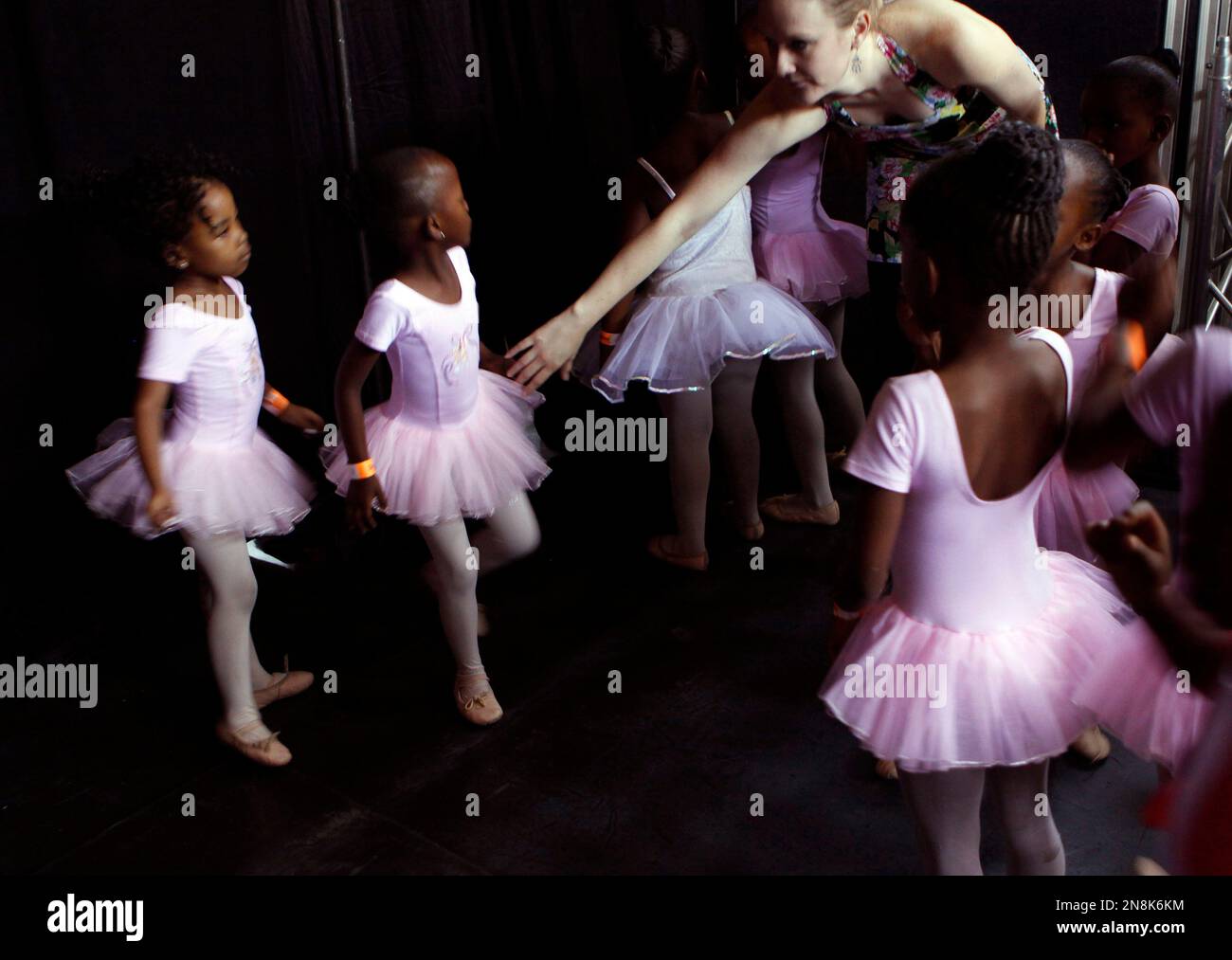 Young ballerinas prepare to go on stage to perform a dance, in Alexandra Township north of ...