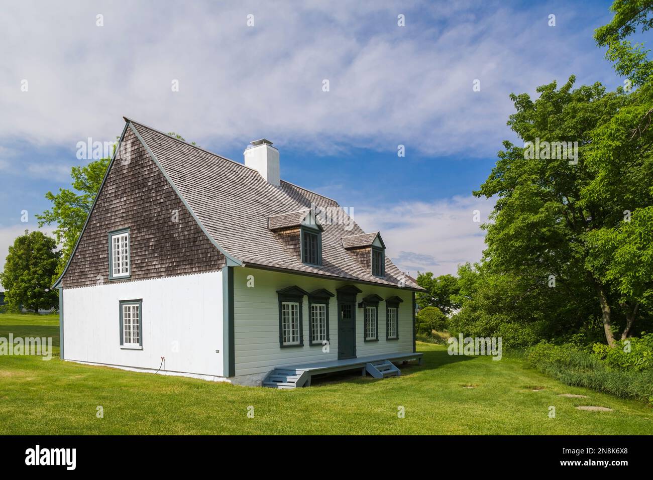 Old 1809 French regime cottage style home facade with white planked ...