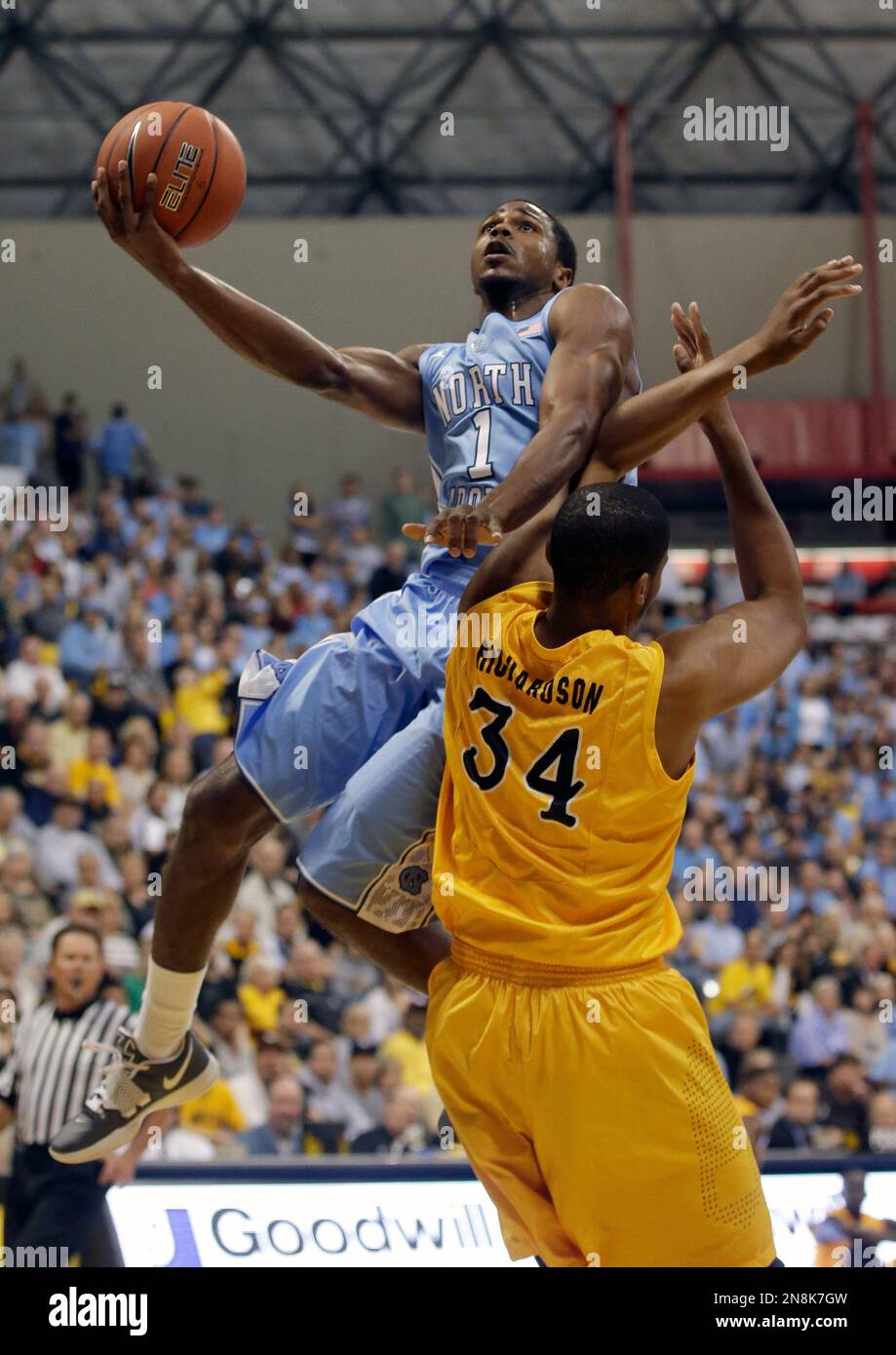 North Carolina's Dexter Strickland, top, drives to the basket past Long ...