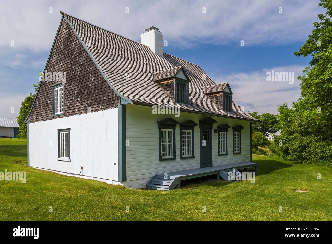 Old 1809 French regime cottage style home facade with white planked ...