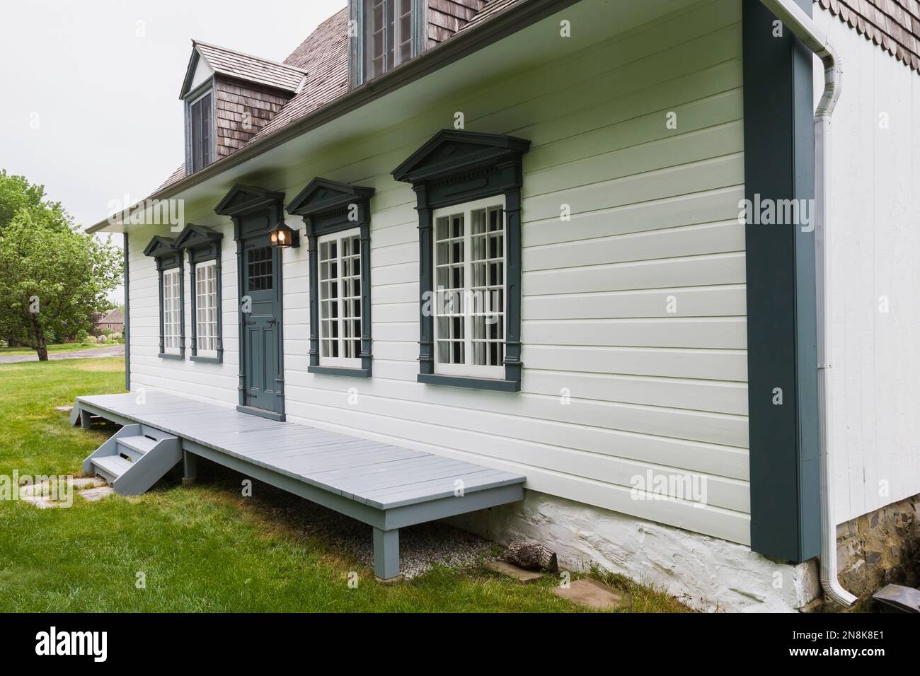 Old 1809 French regime cottage style home facade with white planked ...