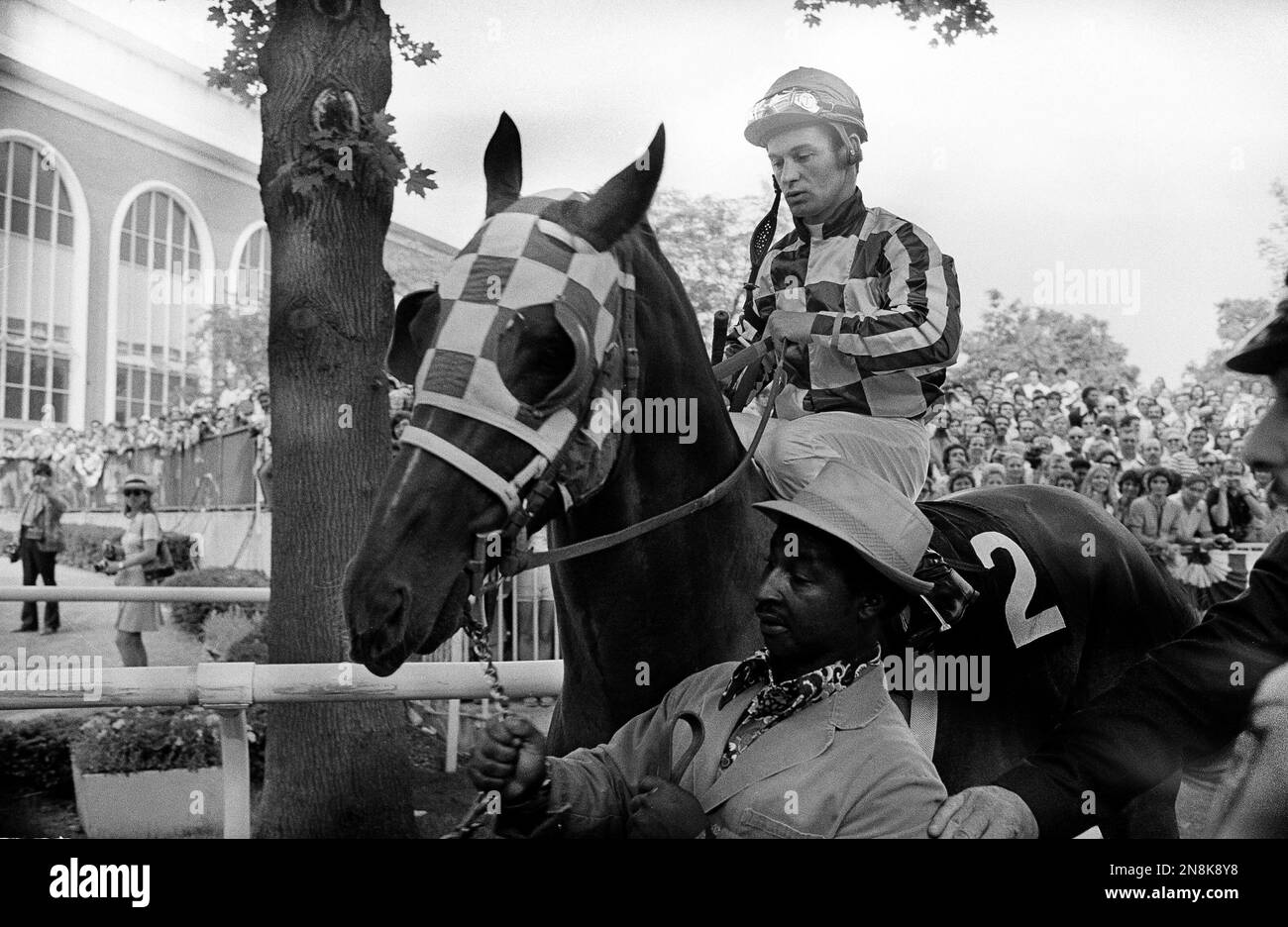 Jockey Ron Turcotte sits on Secretariat on their way from the paddock ...