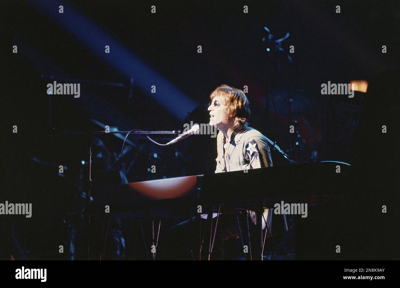John Lennon performs on the keyboard during "One To One", a charity ...