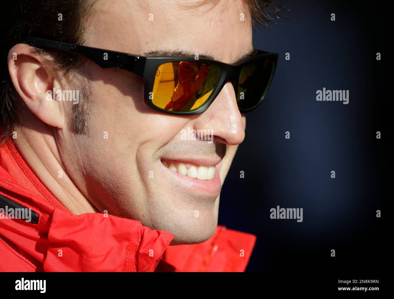 Ferrari driver Fernando Alonso of Spain smiles in the pits before the ...