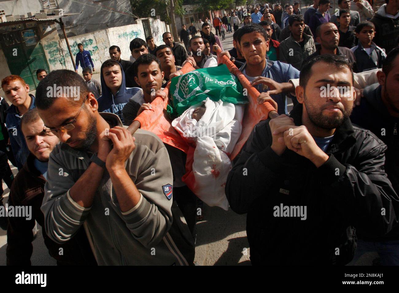 Relatives and friends carry the body of Palestinian Uday Nasser during ...