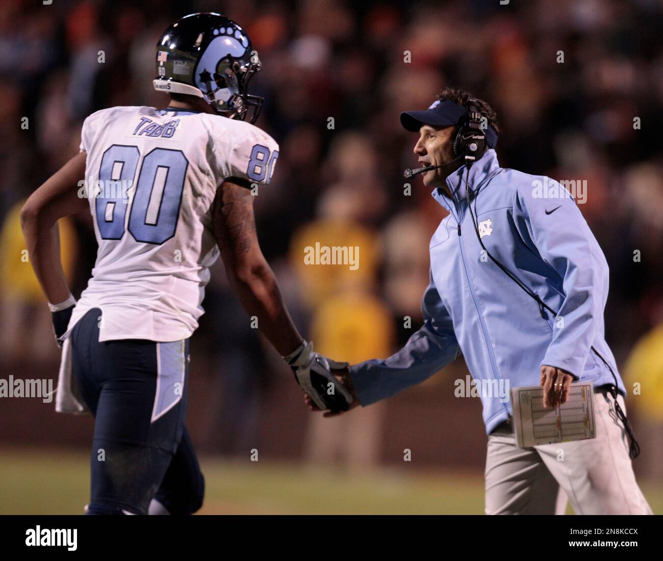 North Carolina head coach Larry Fedora talks with North Carolina tight ...