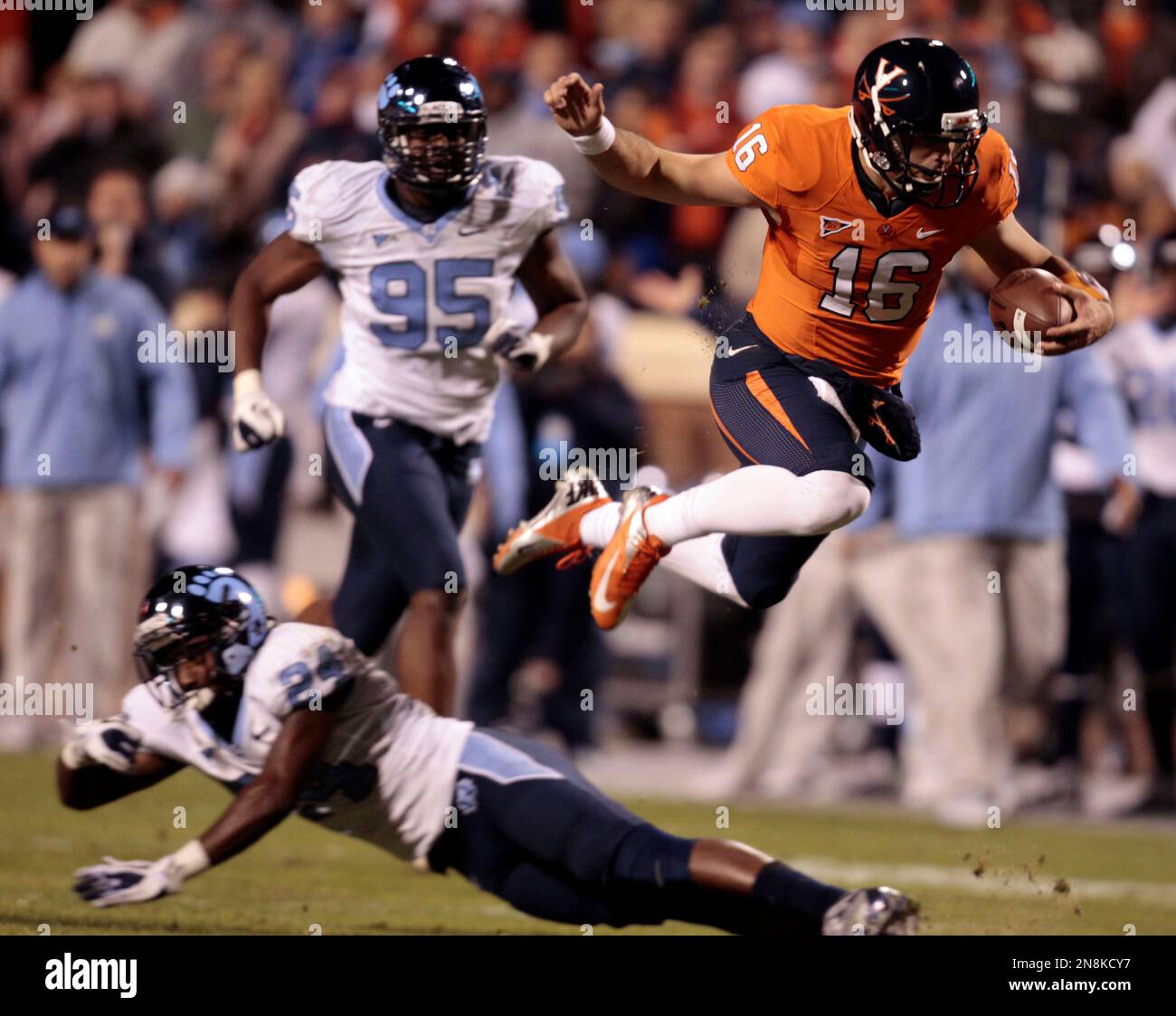 Virginia quarterback Michael Rocco (16) hurdles North Carolina ...