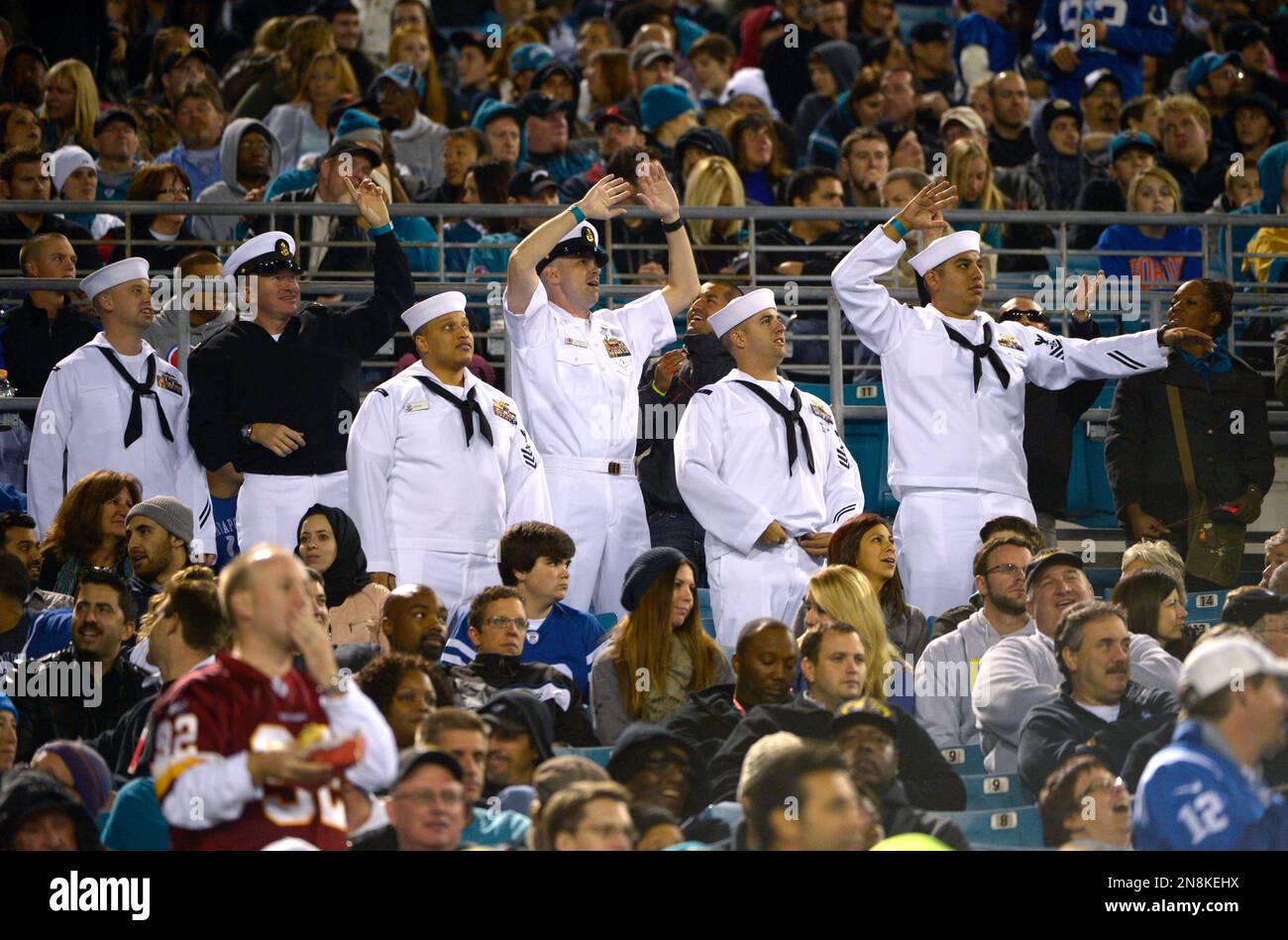 Members of the U.S. Navy cheer from the stands during the first half of ...