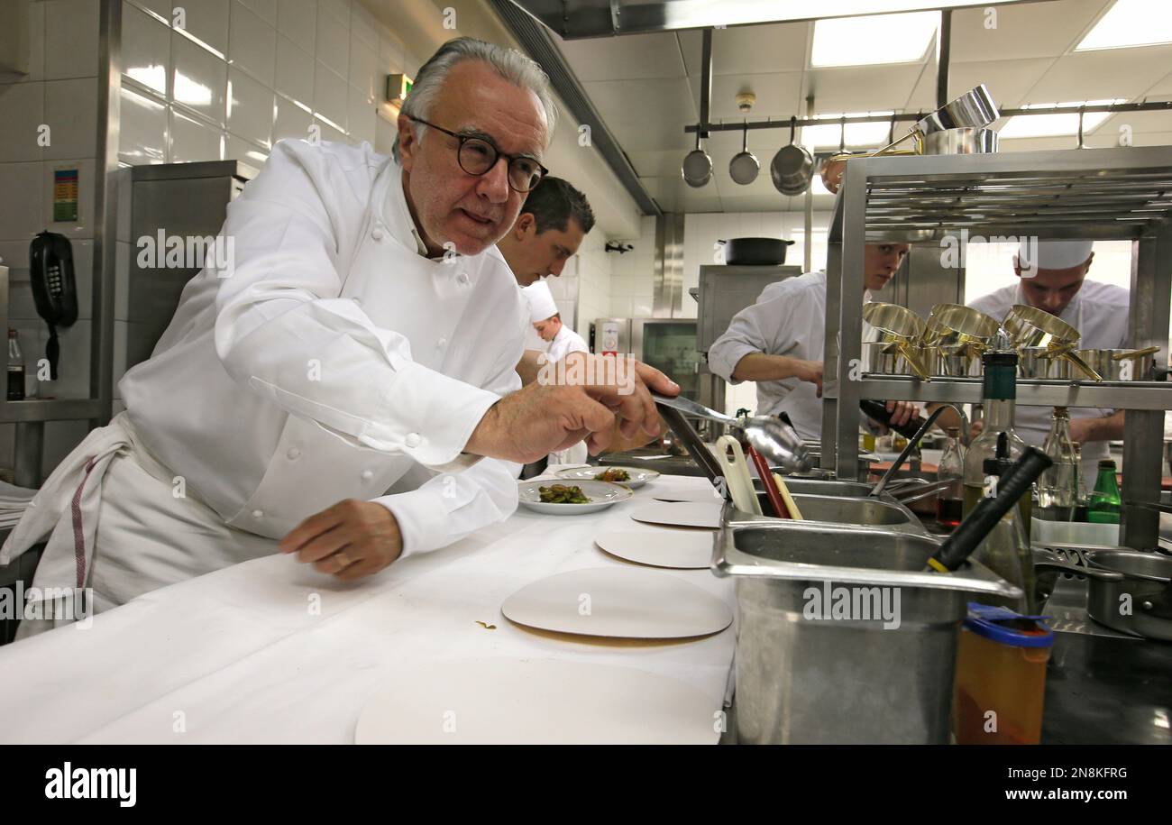 French chef Alain Ducasse works in the kitchen of his restaurant the ...