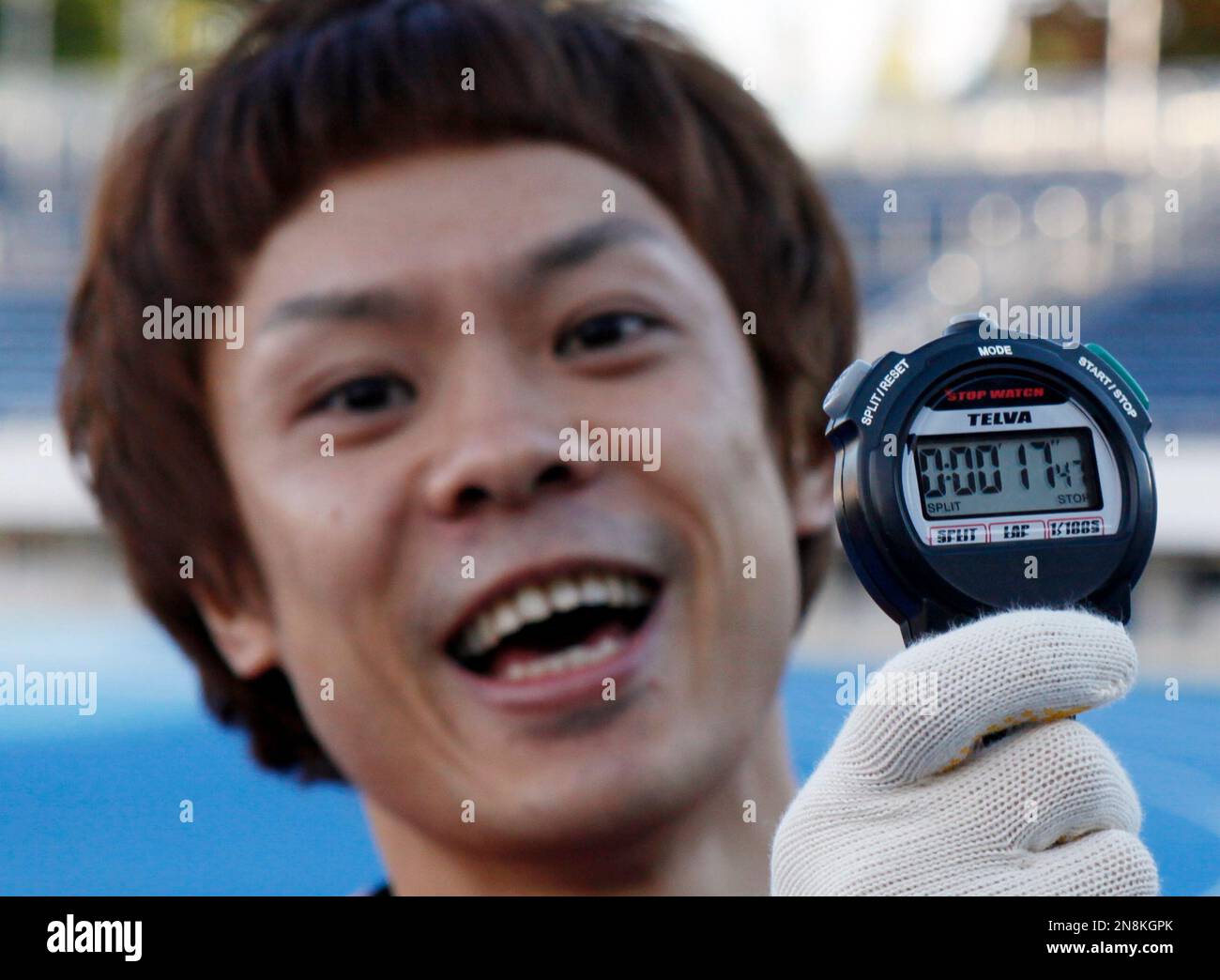 Kenichi Ito shows a watch displaying the Guinness World Record time of 17.47 seconds after ...
