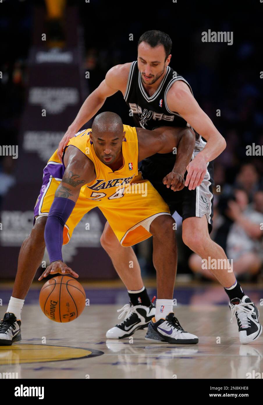 Los Angeles Lakers' Kobe Bryant is defended by San Antonio Spurs' Manu ...