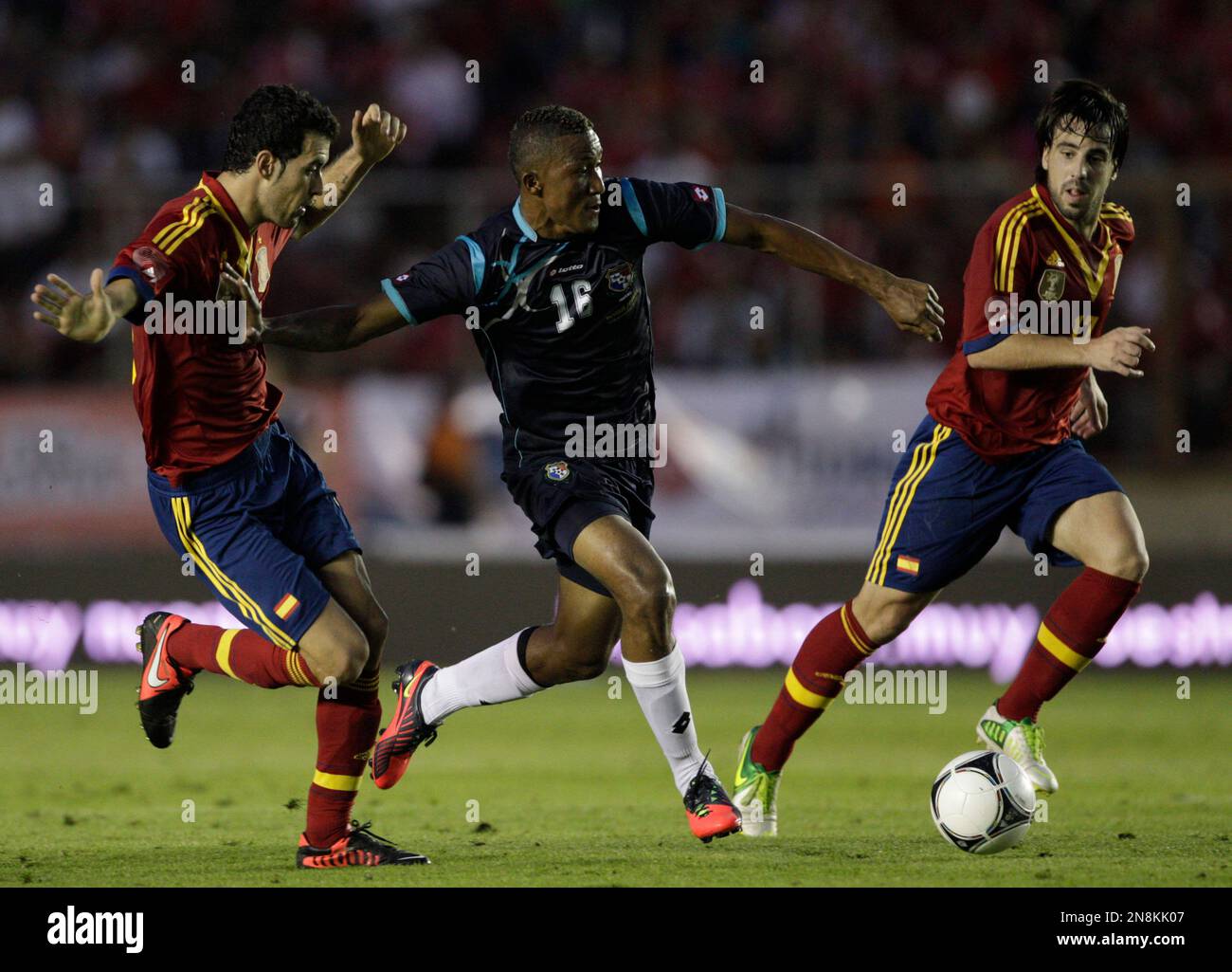 Spain's Sergio Busquets, left, and Benat Etxebarria, right, chases ...