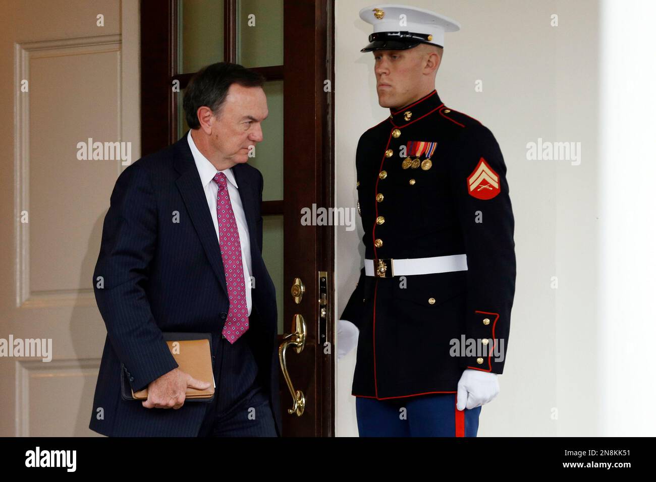 Wal-Mart CEO Mike Duke, left, leave the West Wing of the White House ...