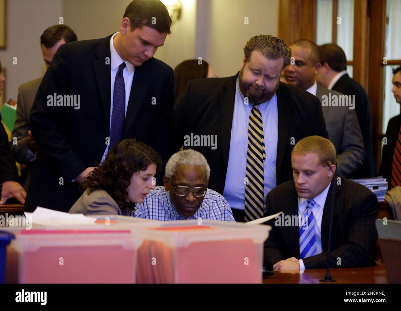 Surrounded by attorneys, clockwise from bottom left, Olga Akselrod ...