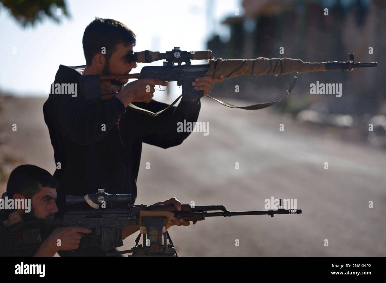 Syrian rebel snipers aim at Syrian army positions on the outskirts of ...