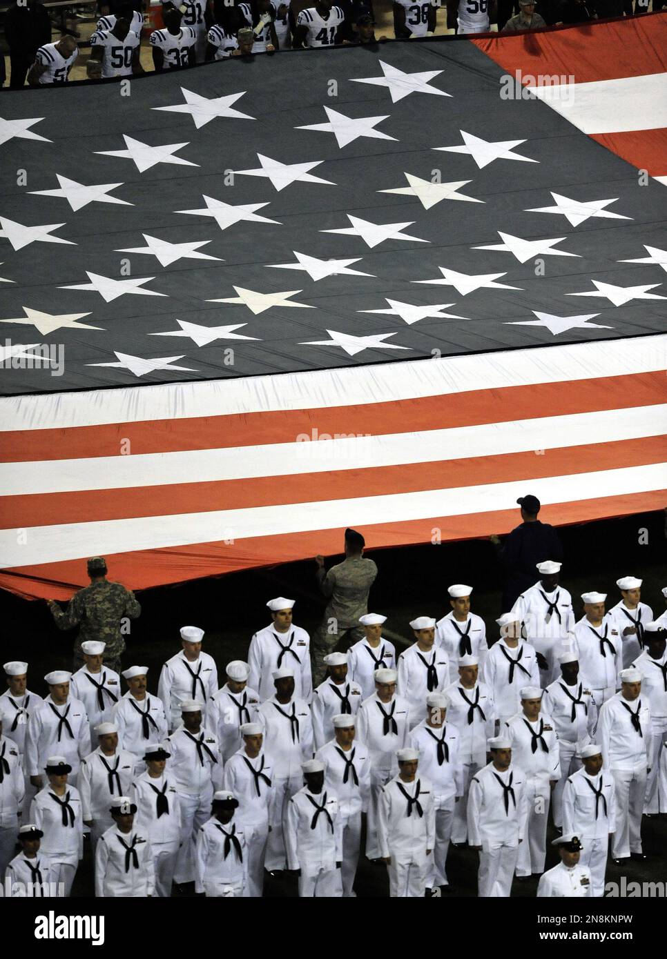 Members of the military take part in a Salute to Service during opening ...