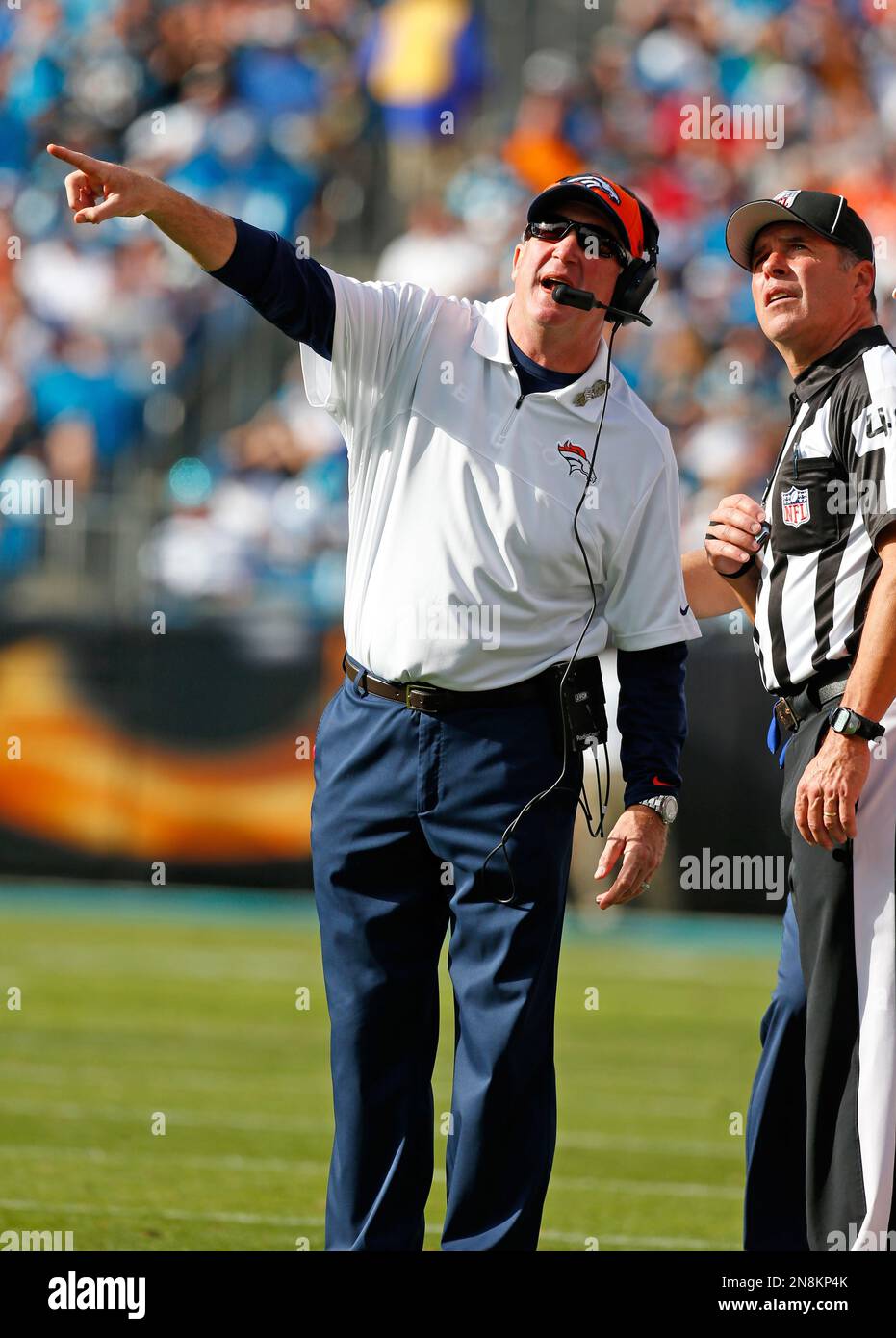 Denver Broncos' head coach John Fox tries to point something out to ...