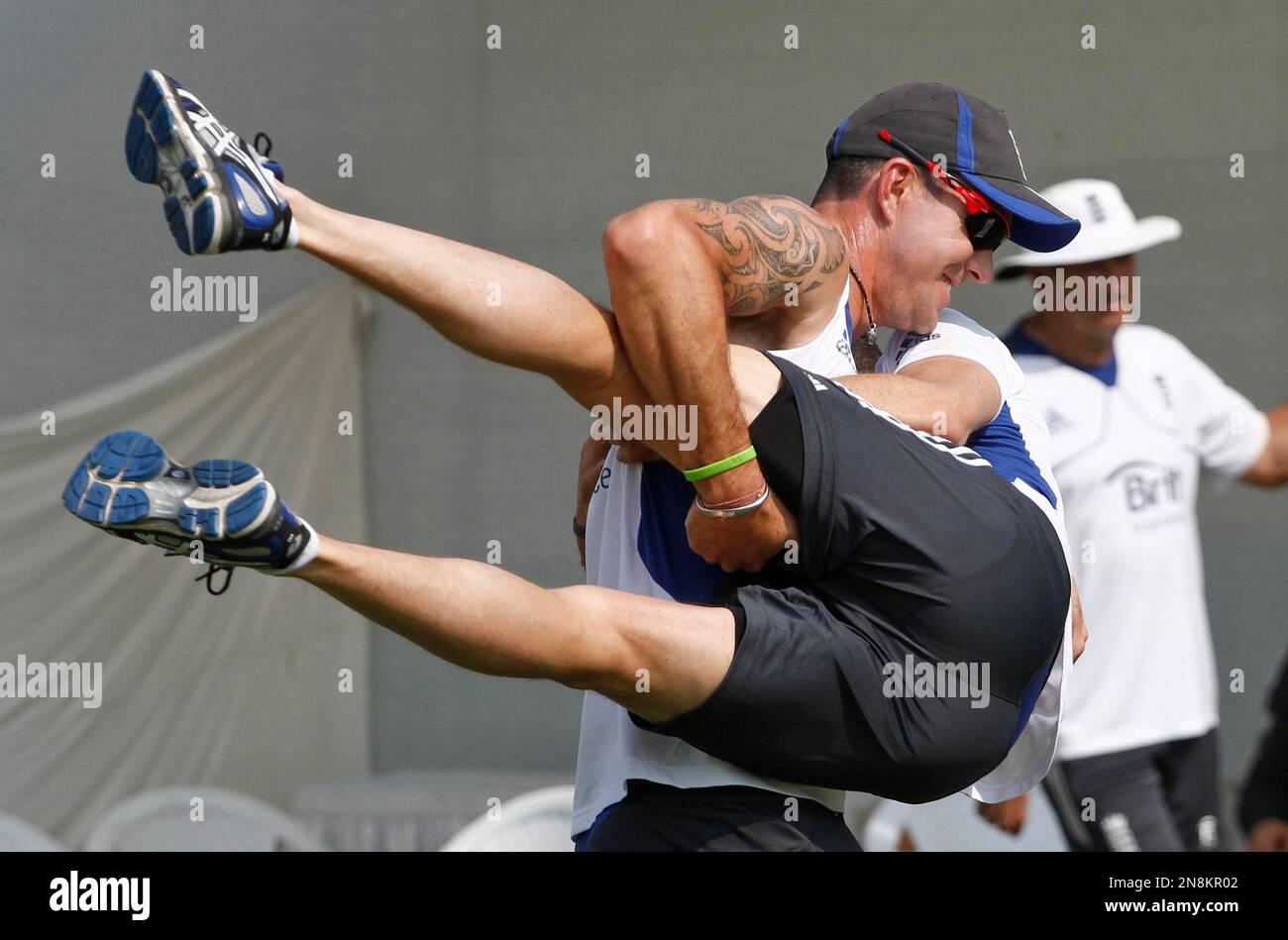 England's Kevin Pietersen lifts physiotherapist Mark Saxby during a ...