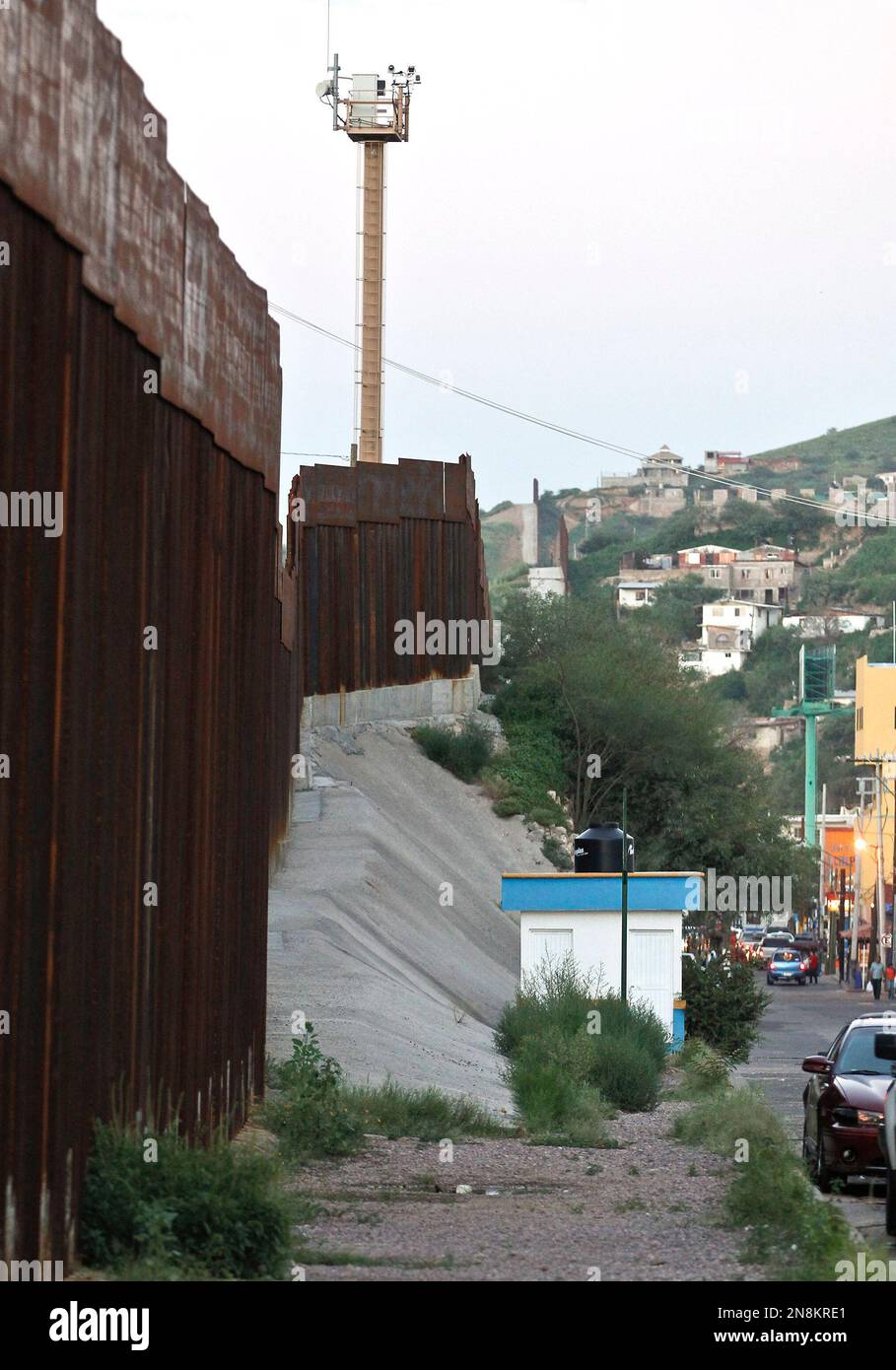 This Aug. 9, 2012, photo shows the border fence with security camera ...