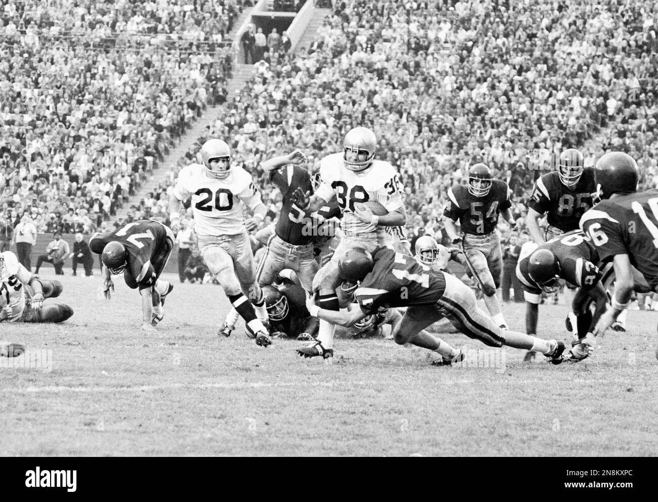 Fullback Ron Dushney (38) of Notre Dame is hauled down by safety Mike ...