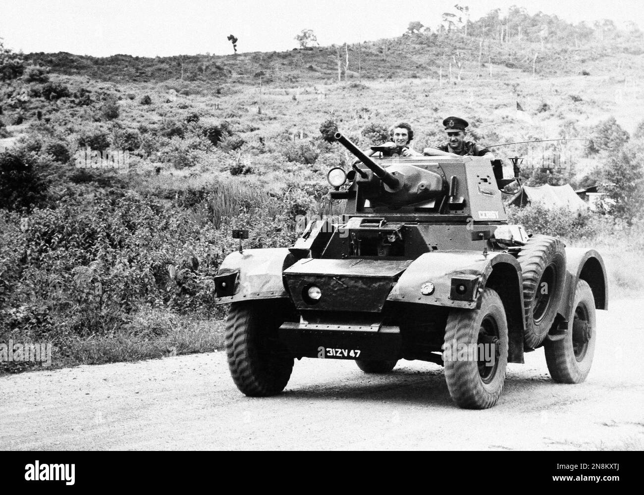 Gen. Sir Gerald Templer and his wife enjoy the countryside on a tour of ...