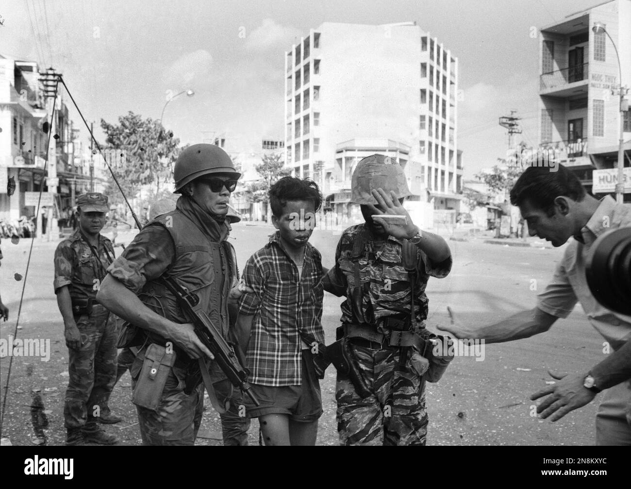 South Vietnamese forces escort suspected Viet Cong officer Nguyen Van ...