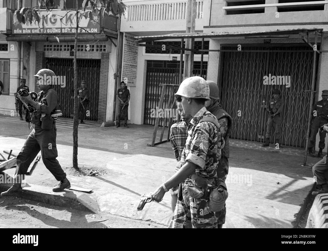 South Vietnamese forces escort suspected Viet Cong officer Nguyen Van ...