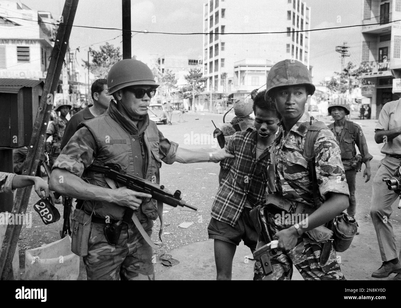 South Vietnamese forces escort suspected Viet Cong officer Nguyen Van Lem (also known as Bay Lop ...