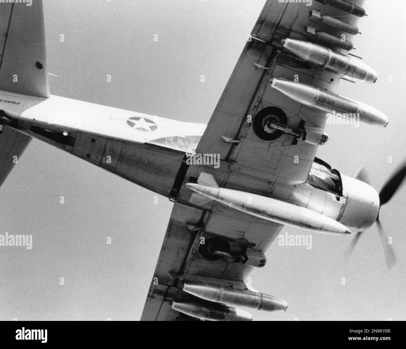 A propeller-driven A-1 Skyraider fighter-bomber carries bombs and ...