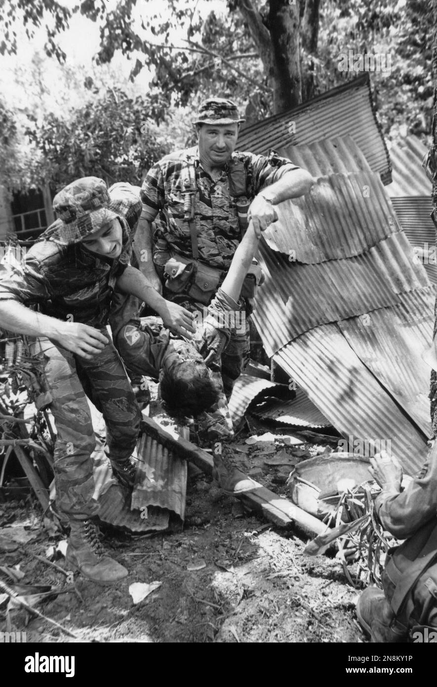U.S. Special Forces men carry a Vietnamese soldier wounded in face-to ...