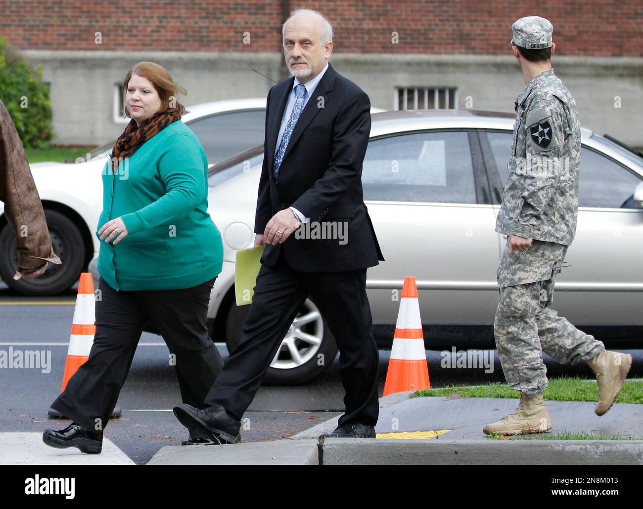 Kari Bales, left, walks with attorney Lance Rosen, center, and a ...