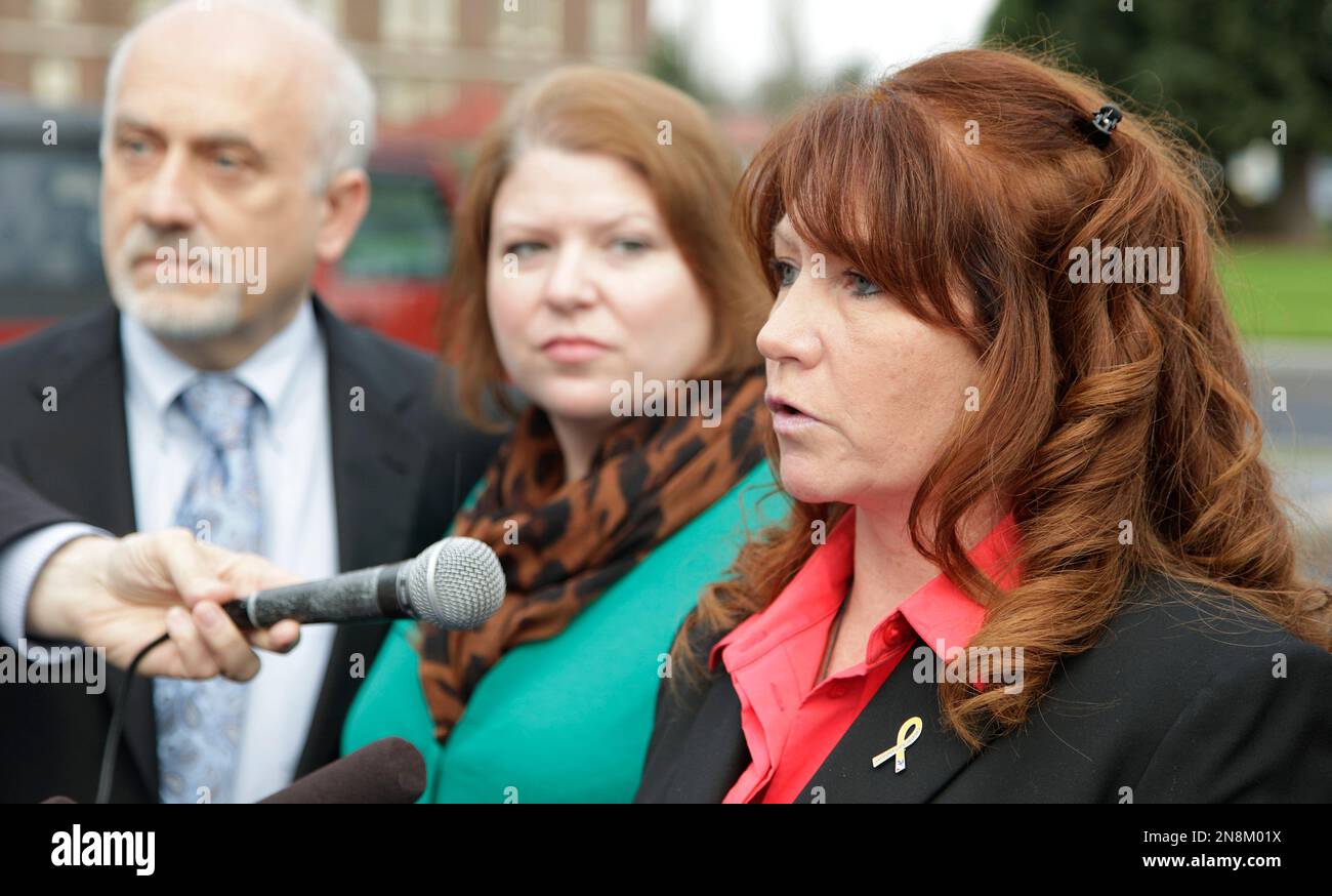 Kari Bales, center, stands next to attorney Lance Rosen, left, as they ...