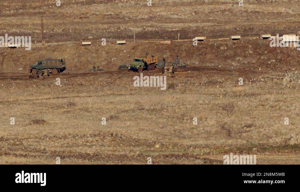Syrian army truck and mobile artillery in position near the Syrian ...