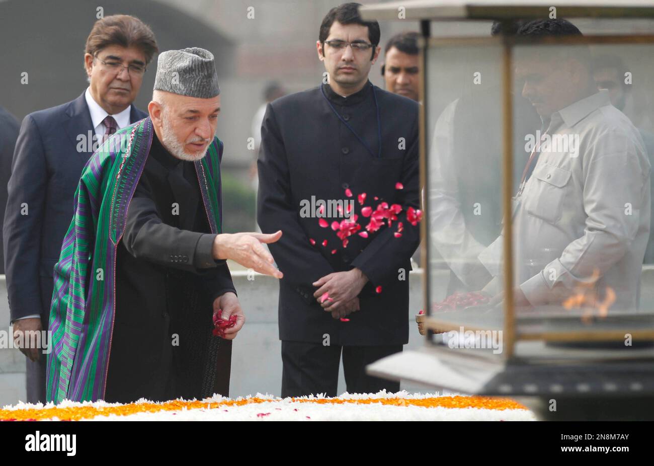 Afghanistan’s President Hamid Karzai lays flower petals at Mahatma ...