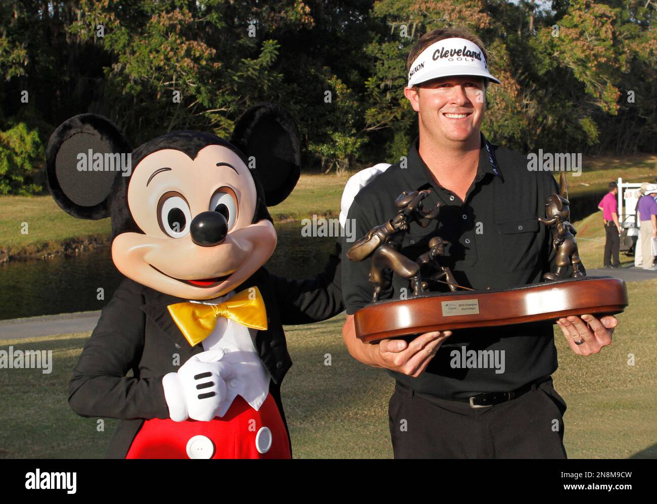 Charlie Beljan, right, and "Mickey Mouse" hold up the trophy on the ...