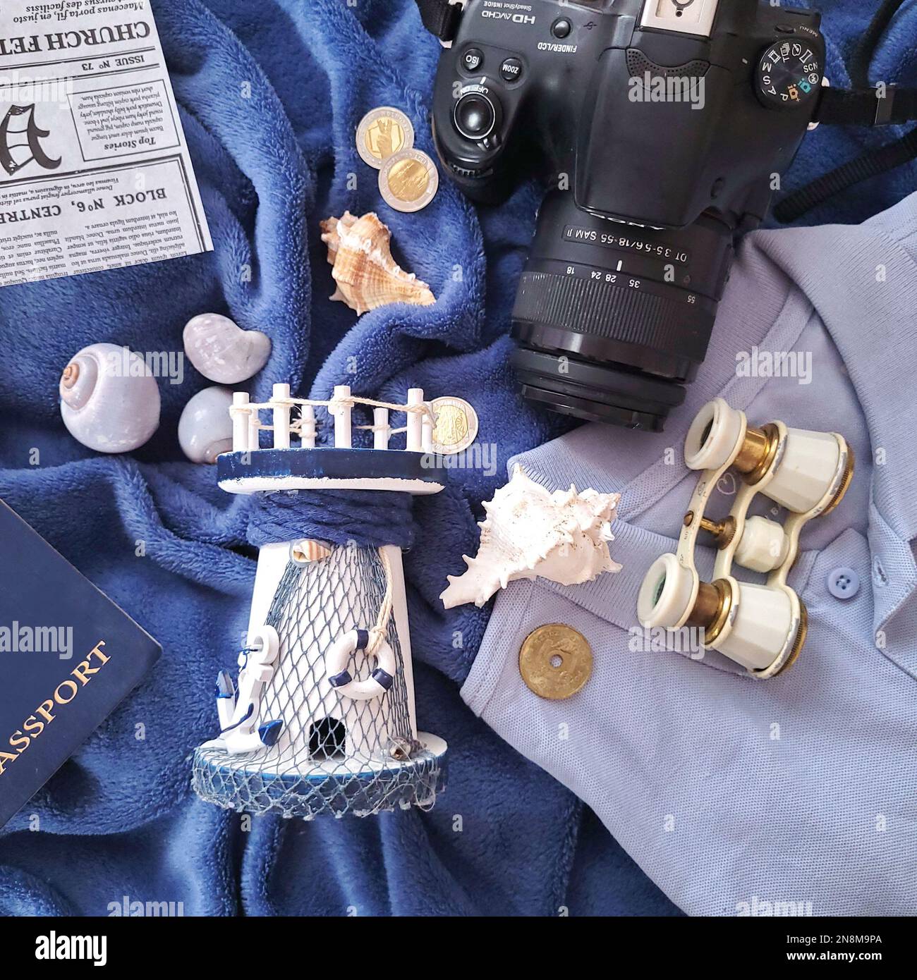 a memory of a journey - scattered objects - a lighthouse, a camera, a ...