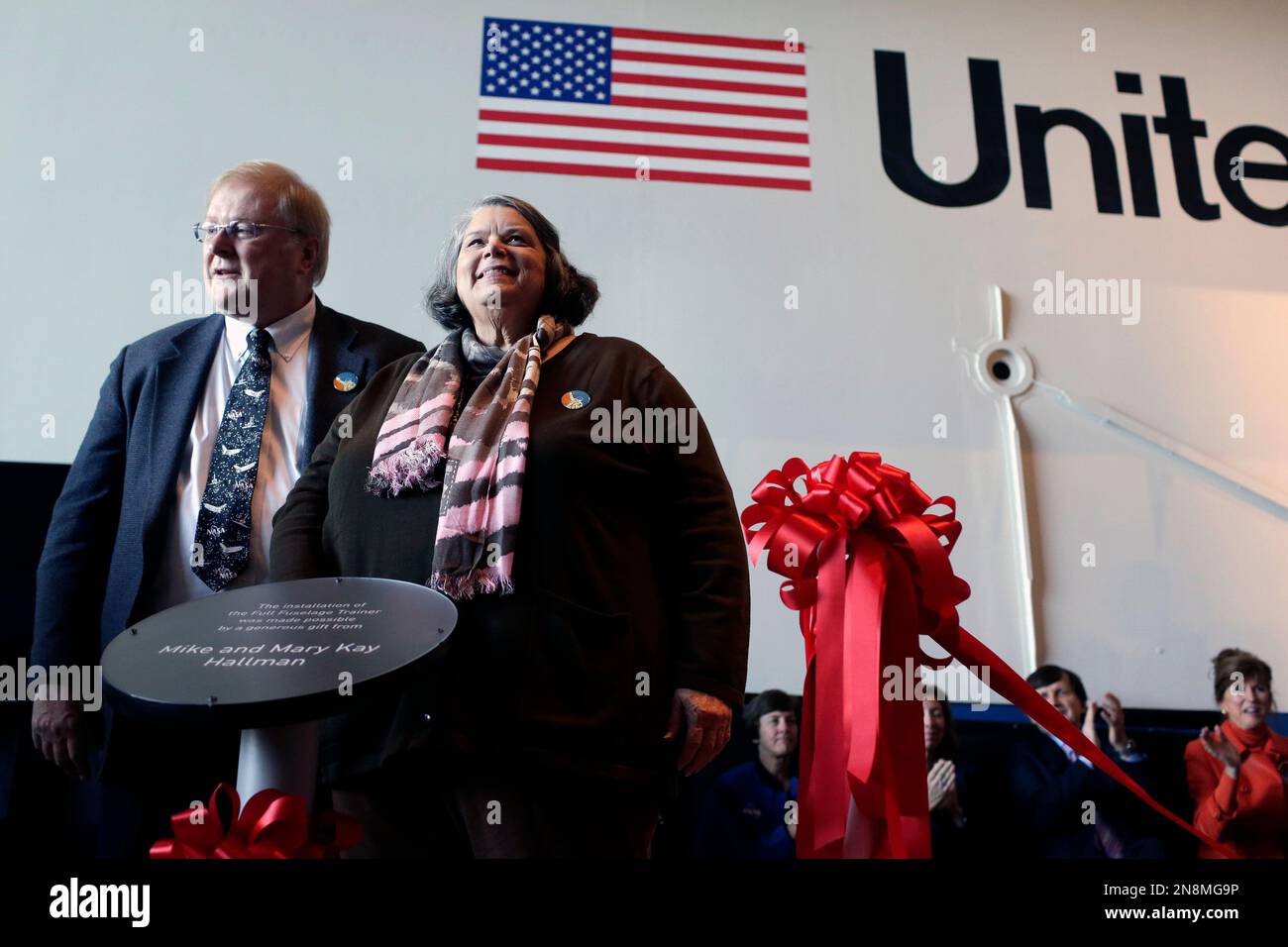 Mike Hallman, left, and Mary Kay Hallman, center, accept a gift in ...