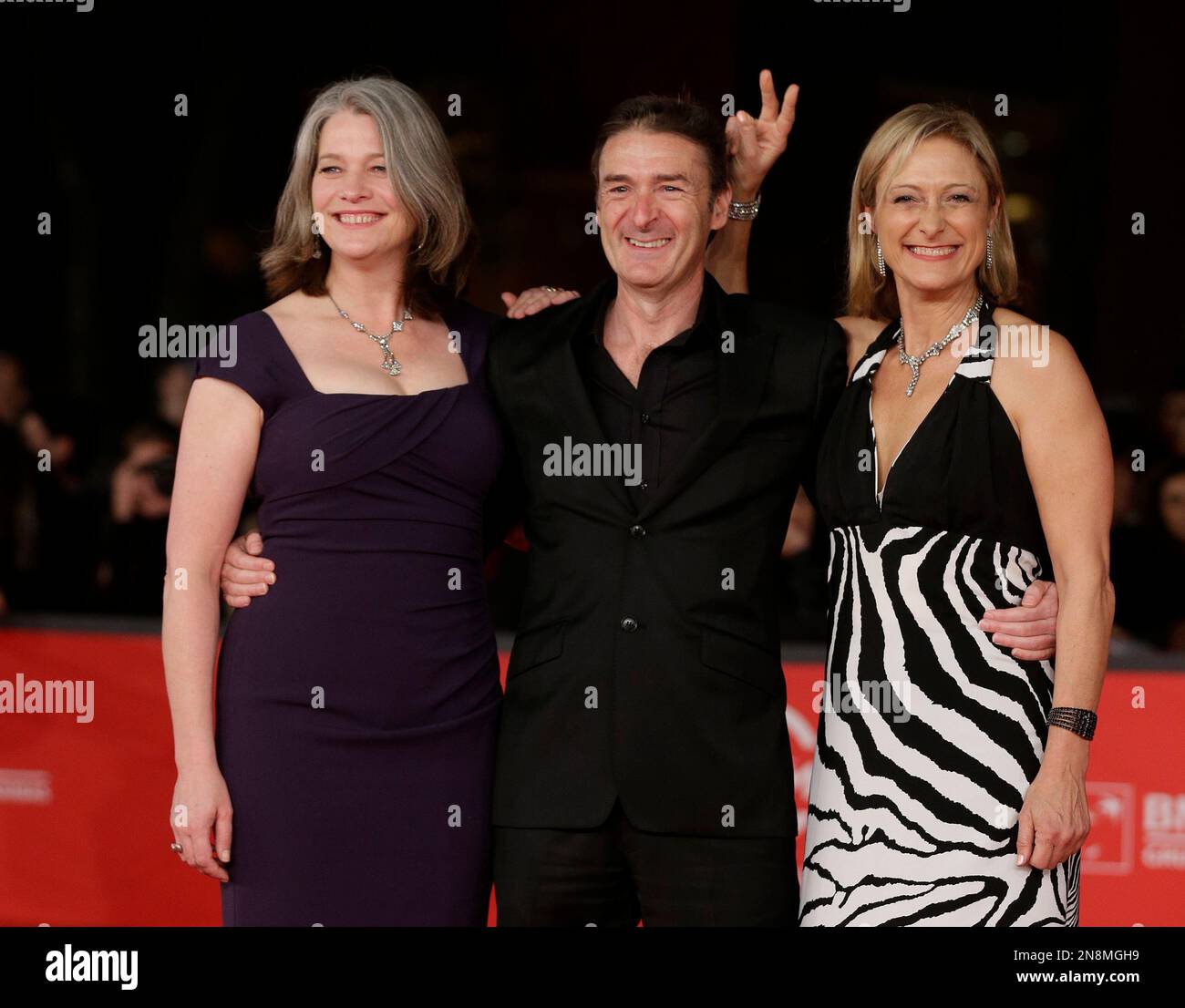 Director Paul J. Hogan, center, arrives on the red carpet flanked by ...