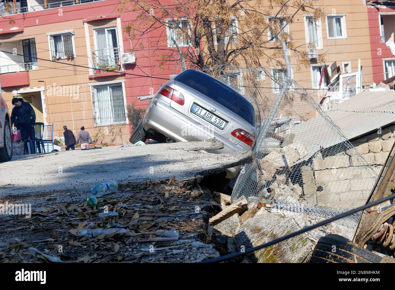Hatay, Turkey. 8th Feb, 2023. A car that fell on the road crevice ...