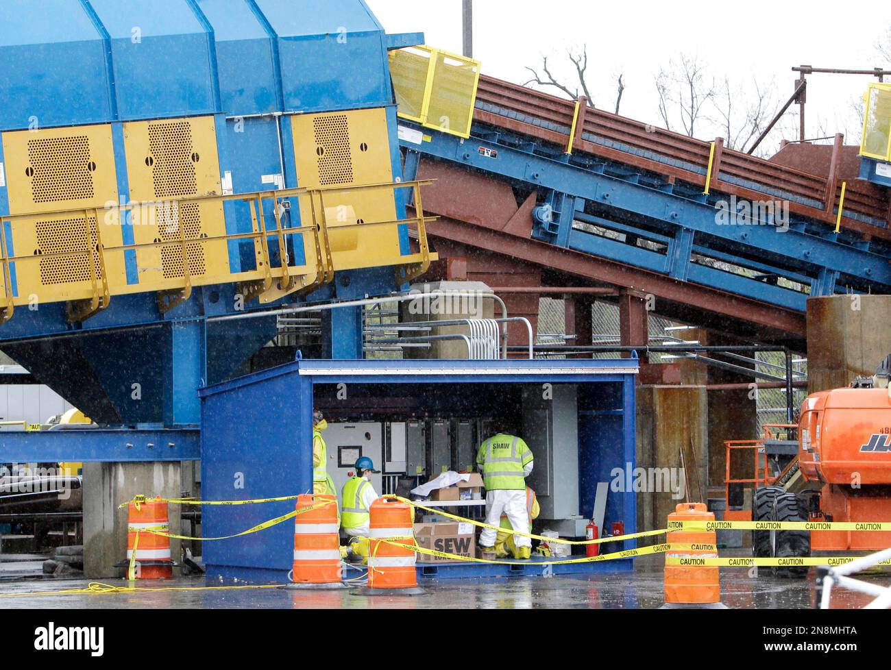 FILE - In this May 4, 2011 file photo, workers ready a machine that ...
