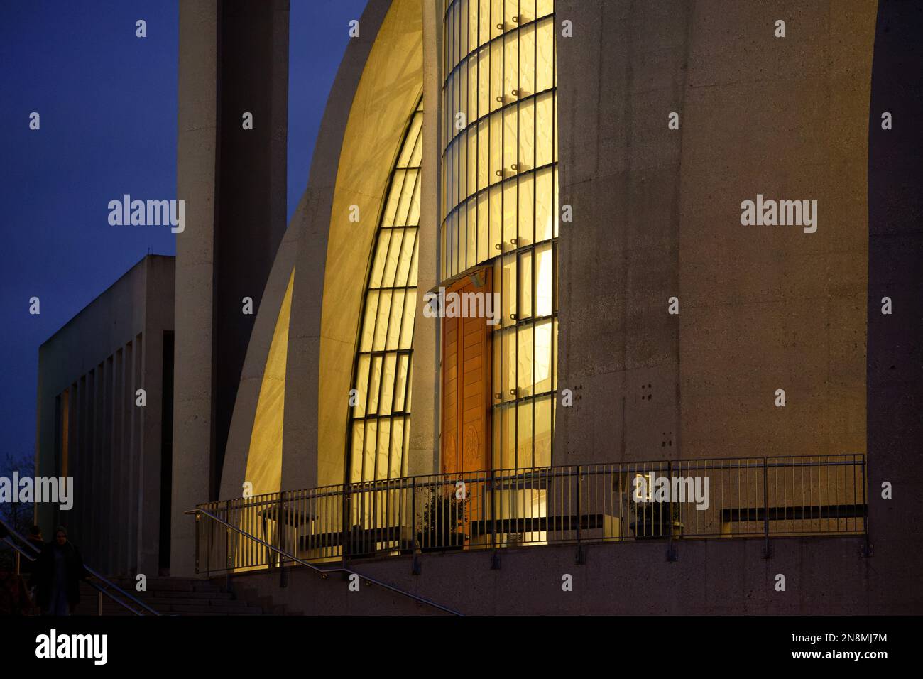 illuminated entrance of the Central Mosque in Cologne Ehrenfeld at dusk ...