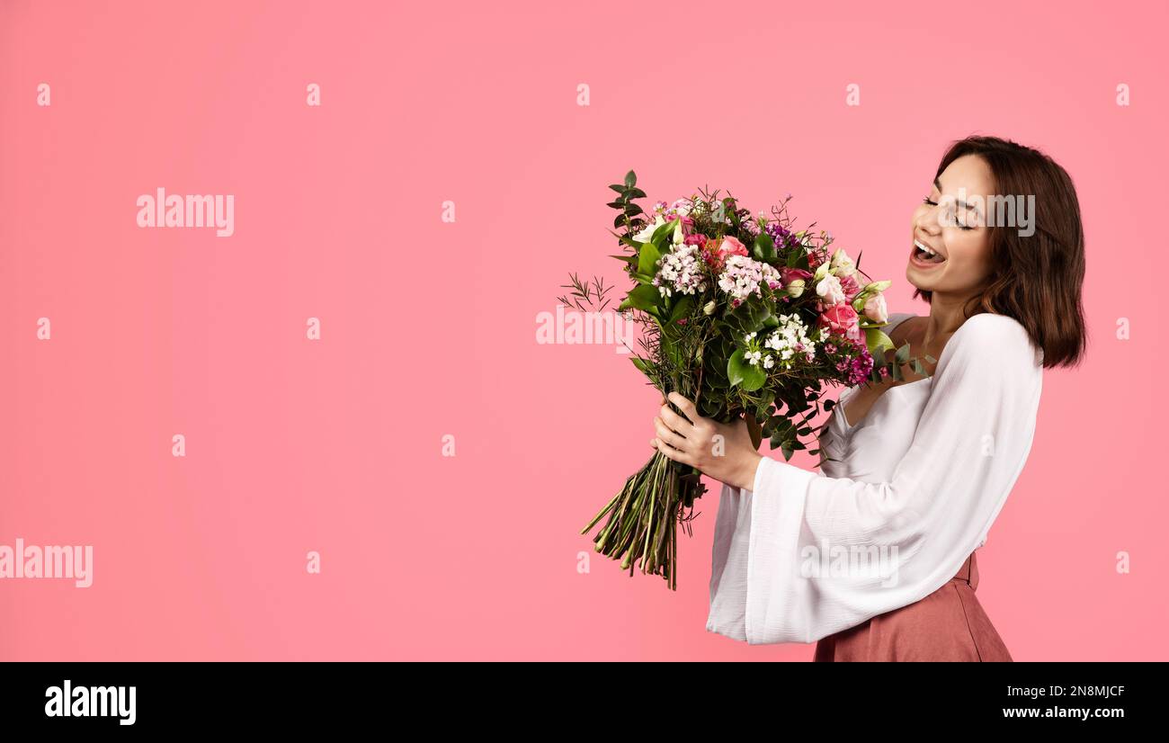 Happy inspired surprised young european woman enjoy bouquet of white ...