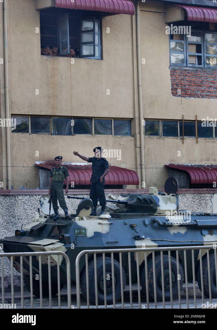 Army soldiers stand atop an armored personnel carrier as people peep in ...