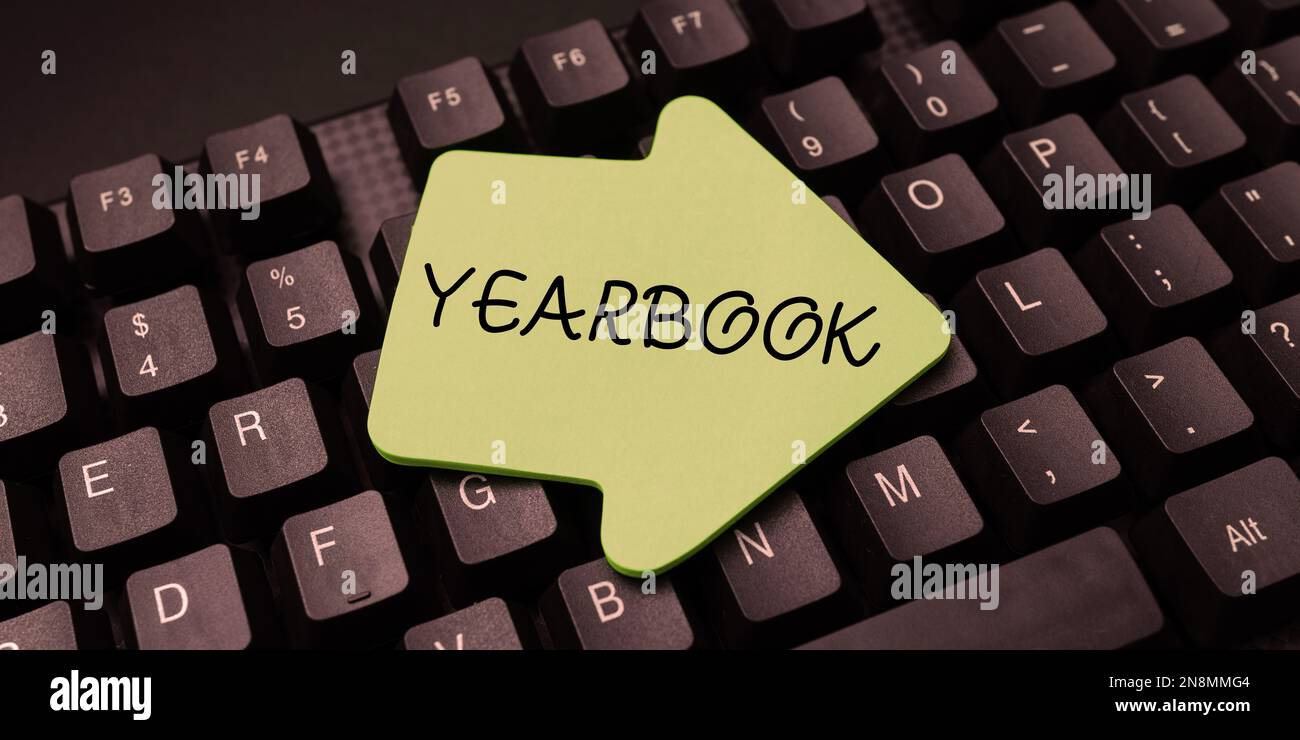 Sign displaying Yearbook. Word for publication compiled by graduating ...