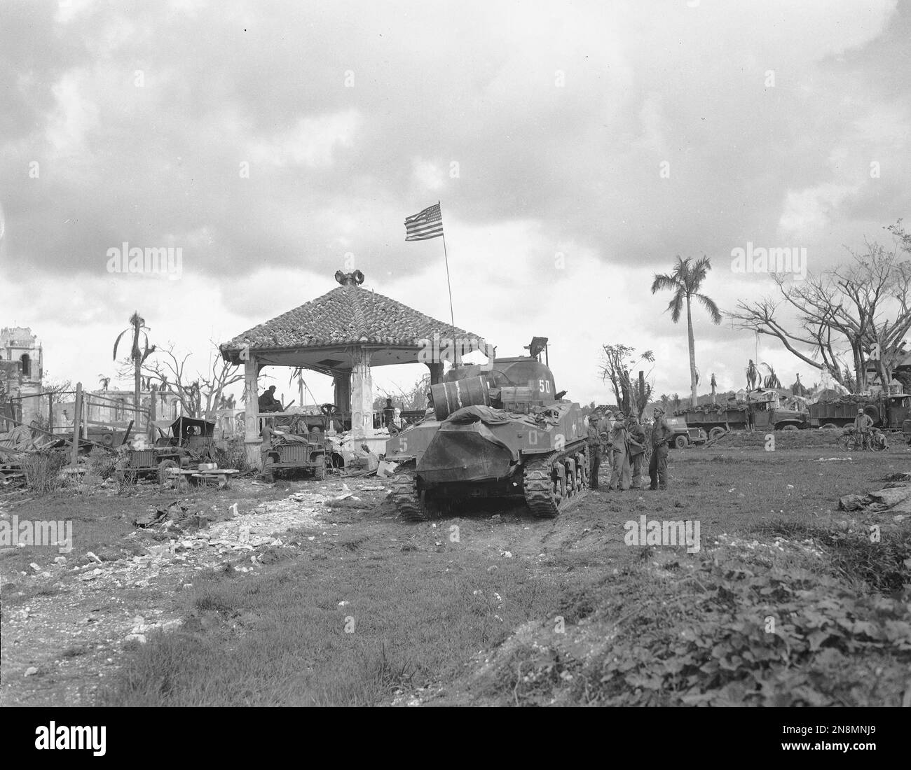 An American flag flies atop the first U.S. tank to lead the push to ...
