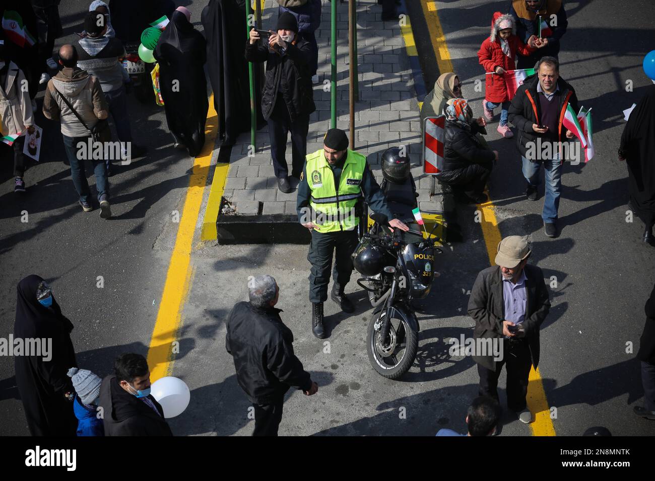 Tehran, Tehran, Iran. 11th Feb, 2023. An Iranian policeman (C) stands ...