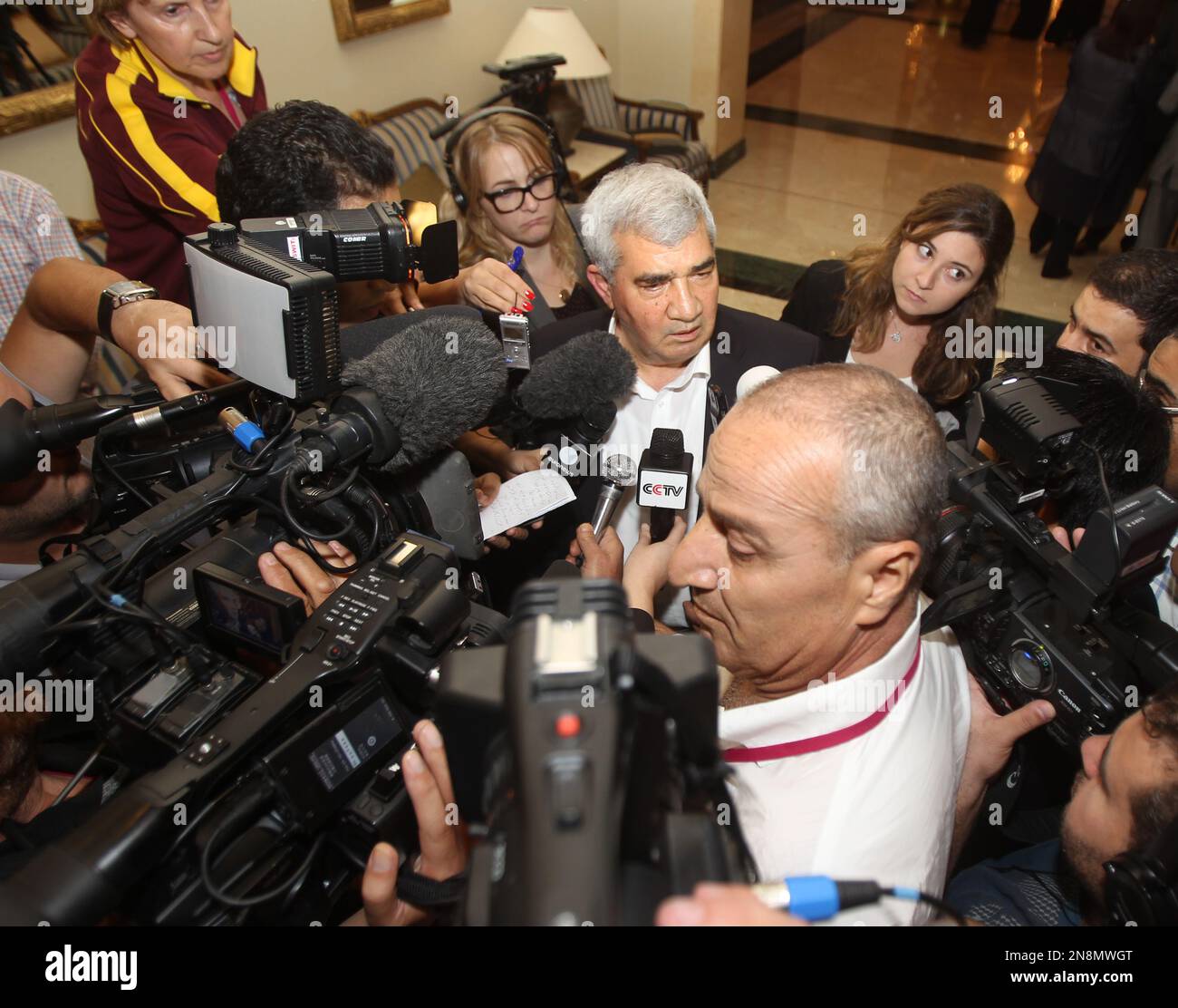 Syrian dissident Riad Seif, center, speaks to the media at the meeting ...